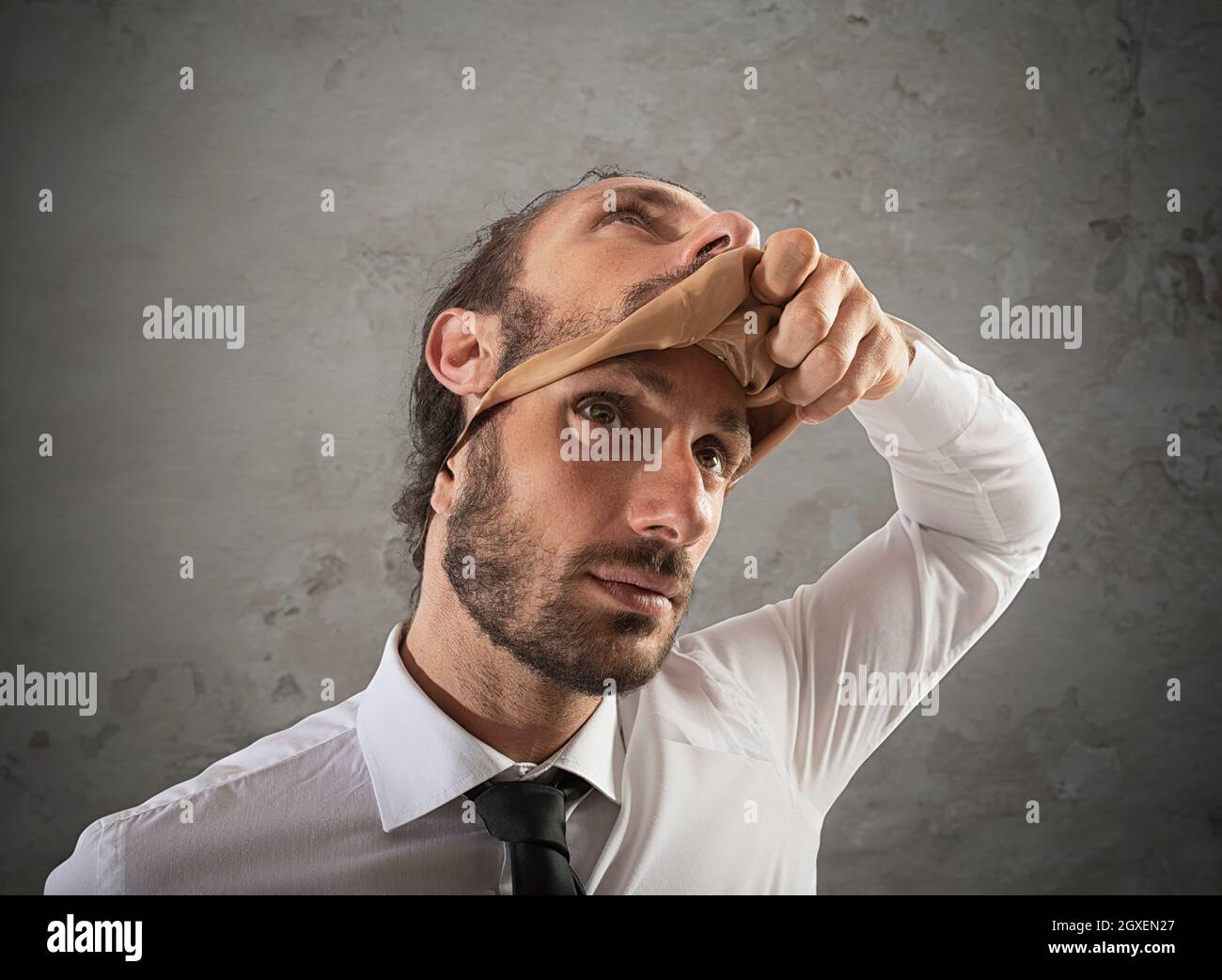 Businessman that removes the mask. Concept of falsity at work Stock ...
