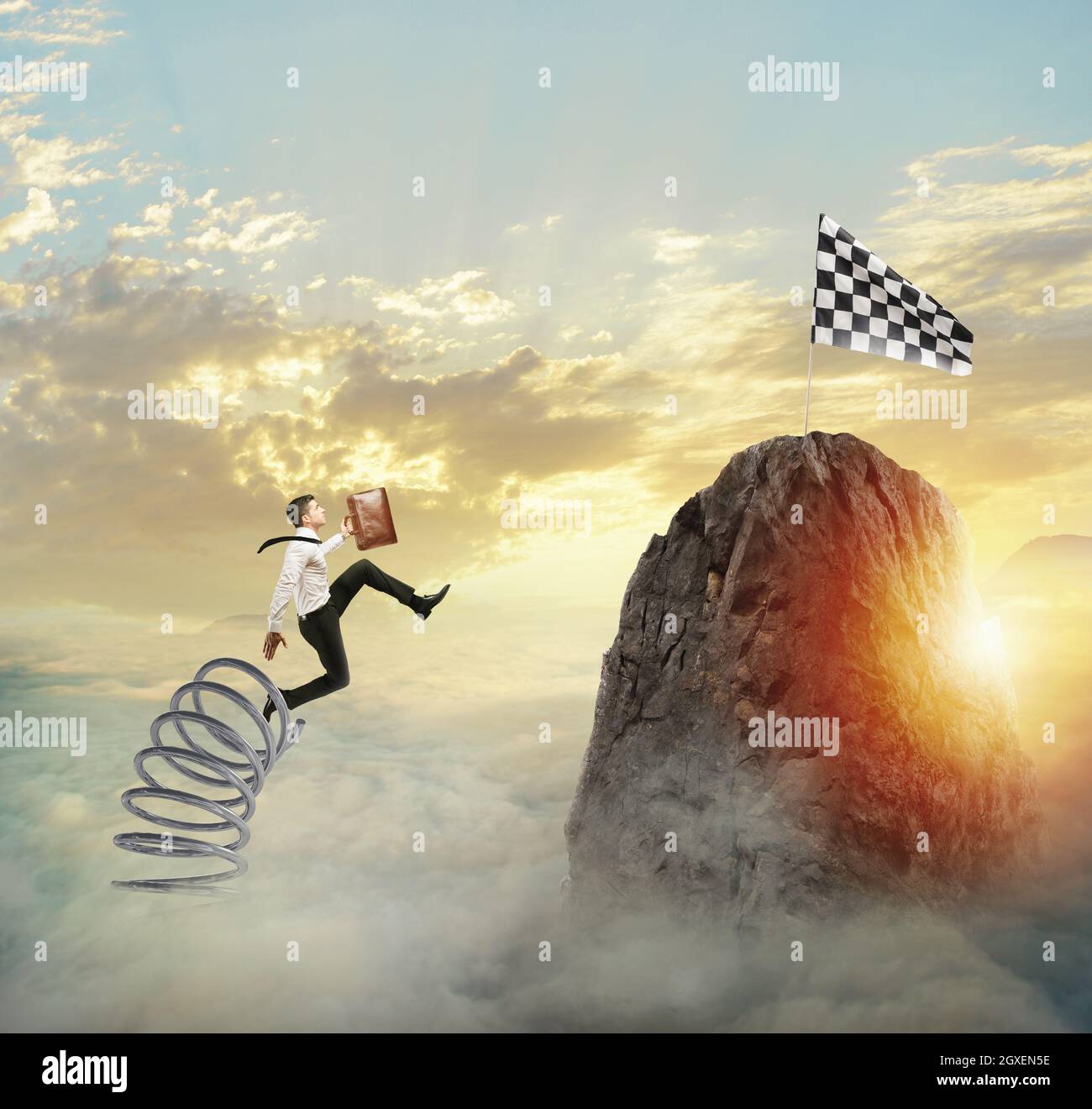 Businessman jumping on a spring to reach the flag at the top of the ...