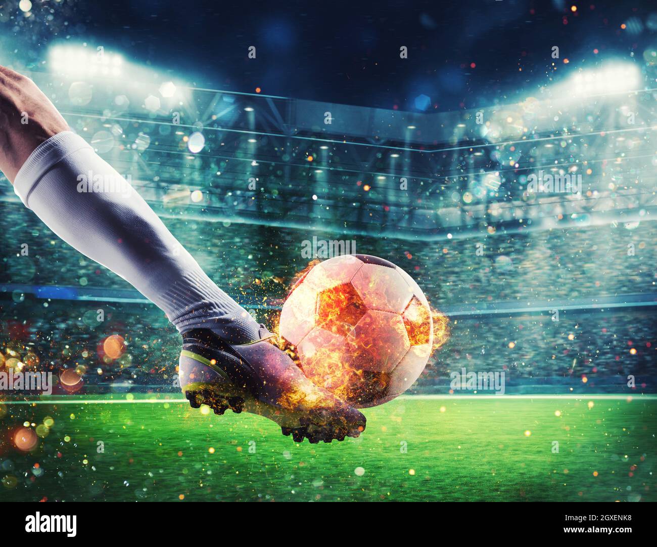Soccer player with soccerball on fire at the illuminated stadium during ...