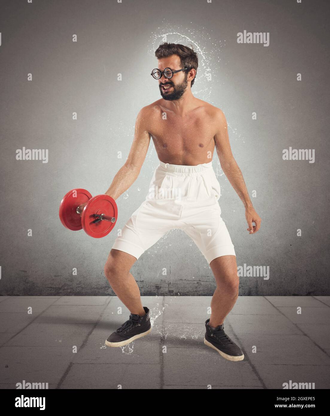 Nerdy guy and awkward lifts of weights Stock Photo - Alamy