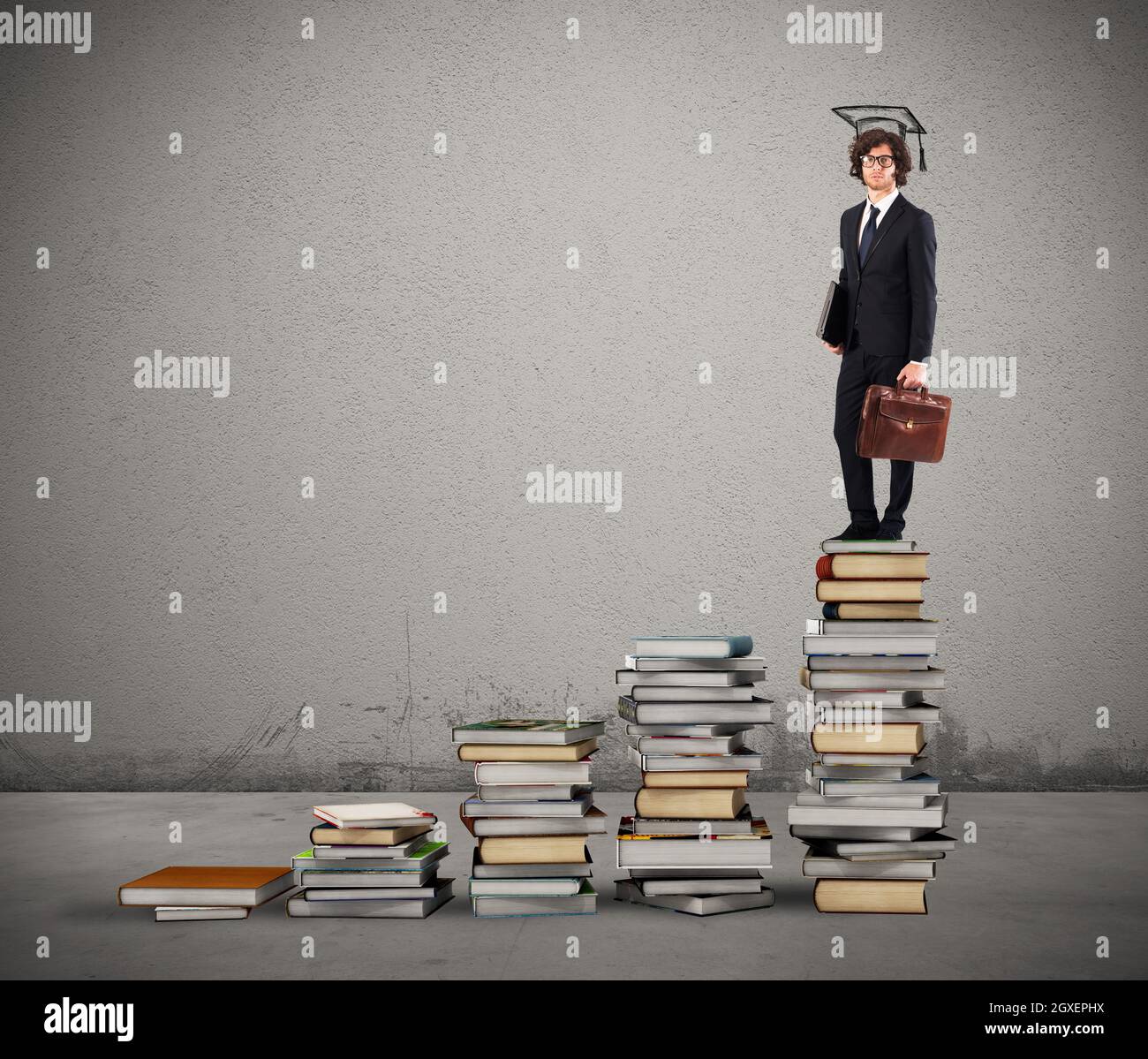 Scale with books and man with graduation hat Stock Photo - Alamy