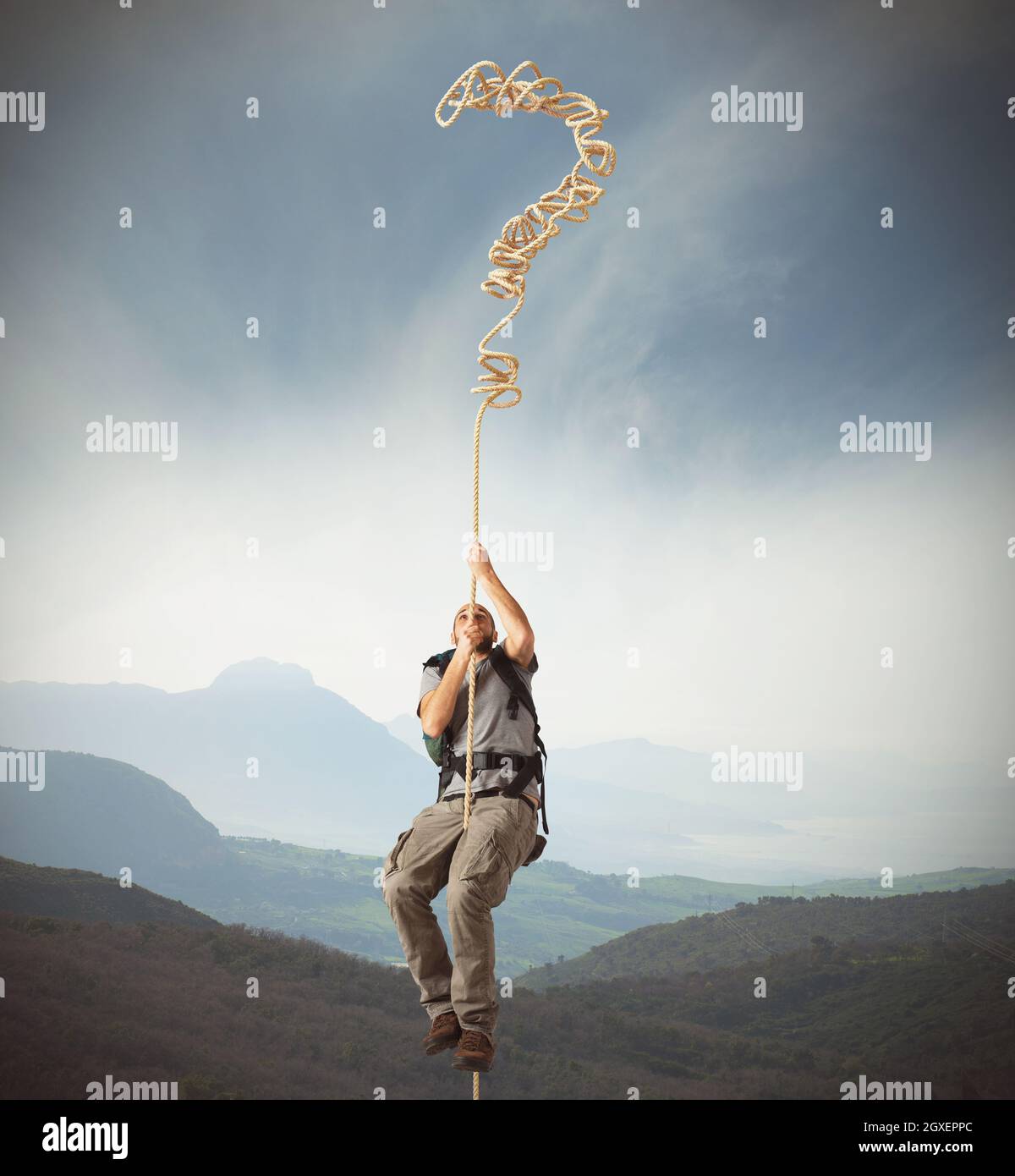 Explorer clinging to a rope of interrogative Stock Photo - Alamy