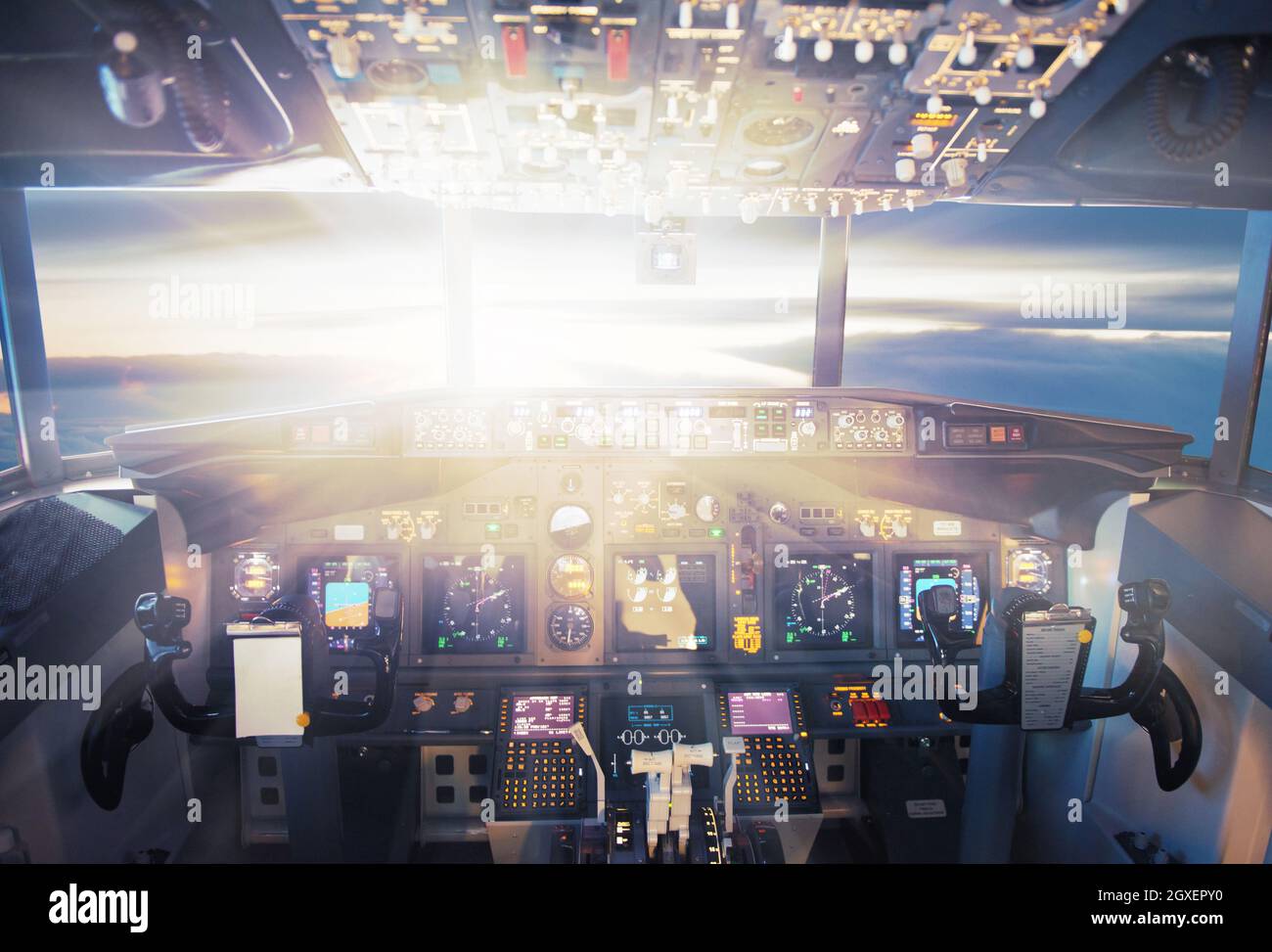 Pilot controls aircraft in the sunset lights Stock Photo - Alamy