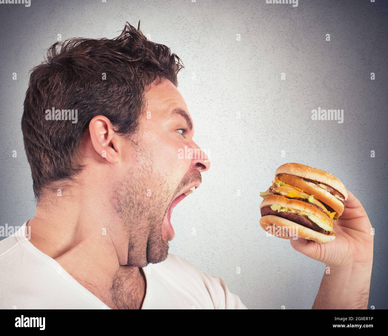 Insatiable and hungry man eating a sandwich Stock Photo - Alamy