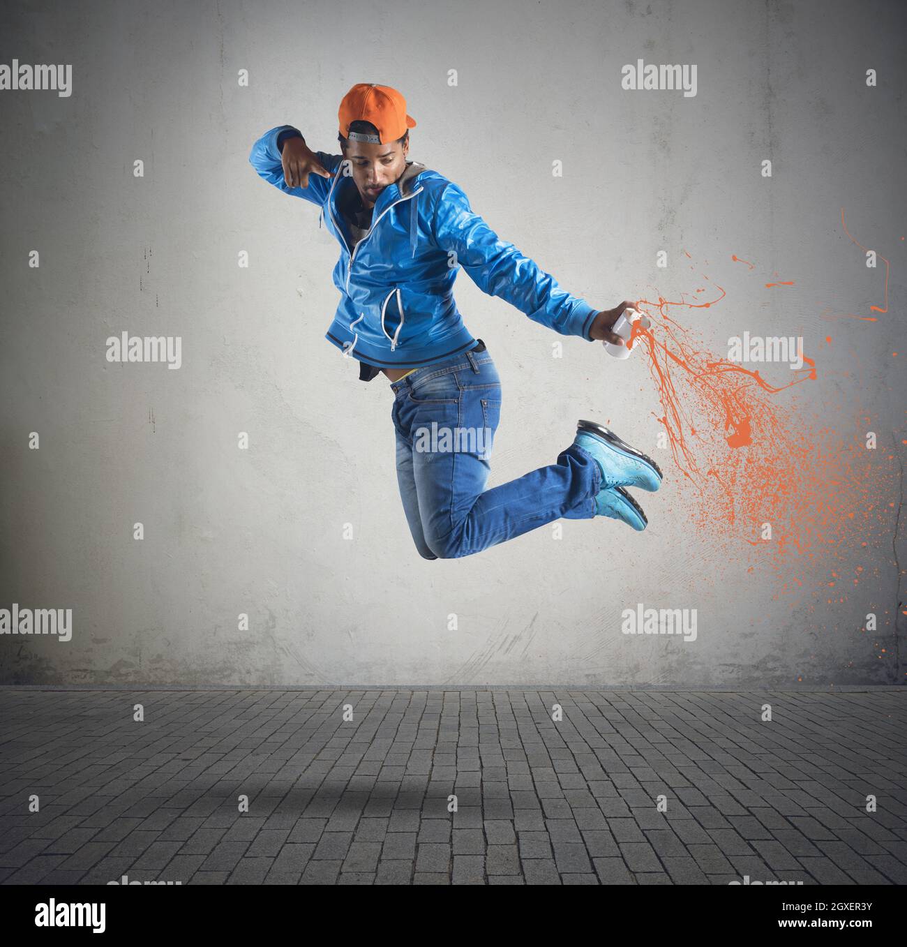 Boy jumps and color with the spray Stock Photo - Alamy
