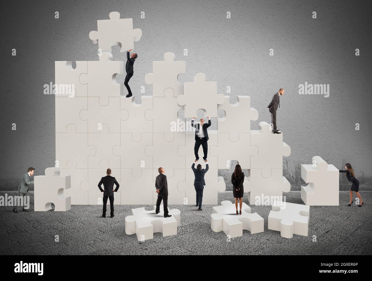 Business team working to build a puzzle Stock Photo - Alamy