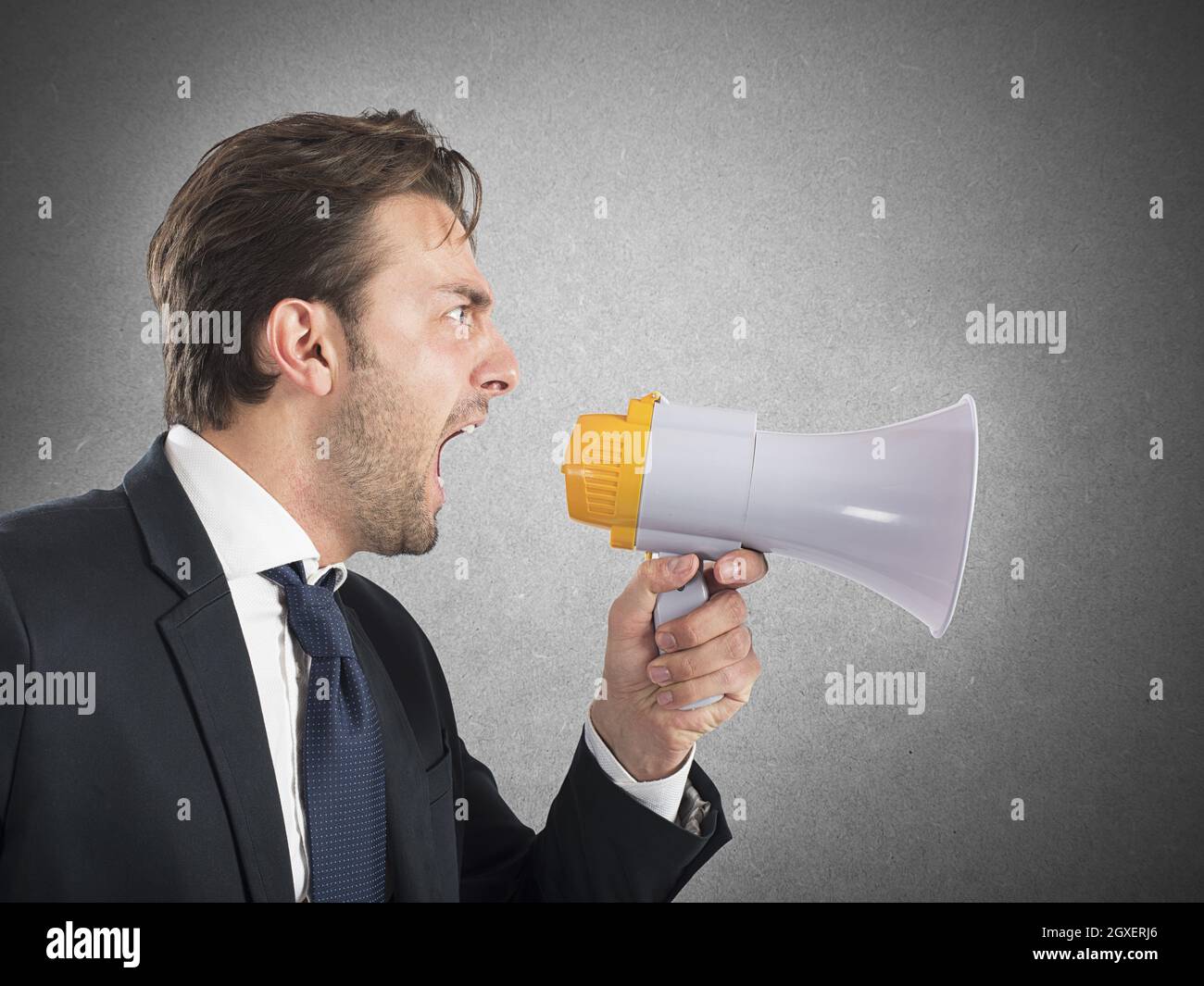Angry business boss shouting with his megaphone Stock Photo - Alamy
