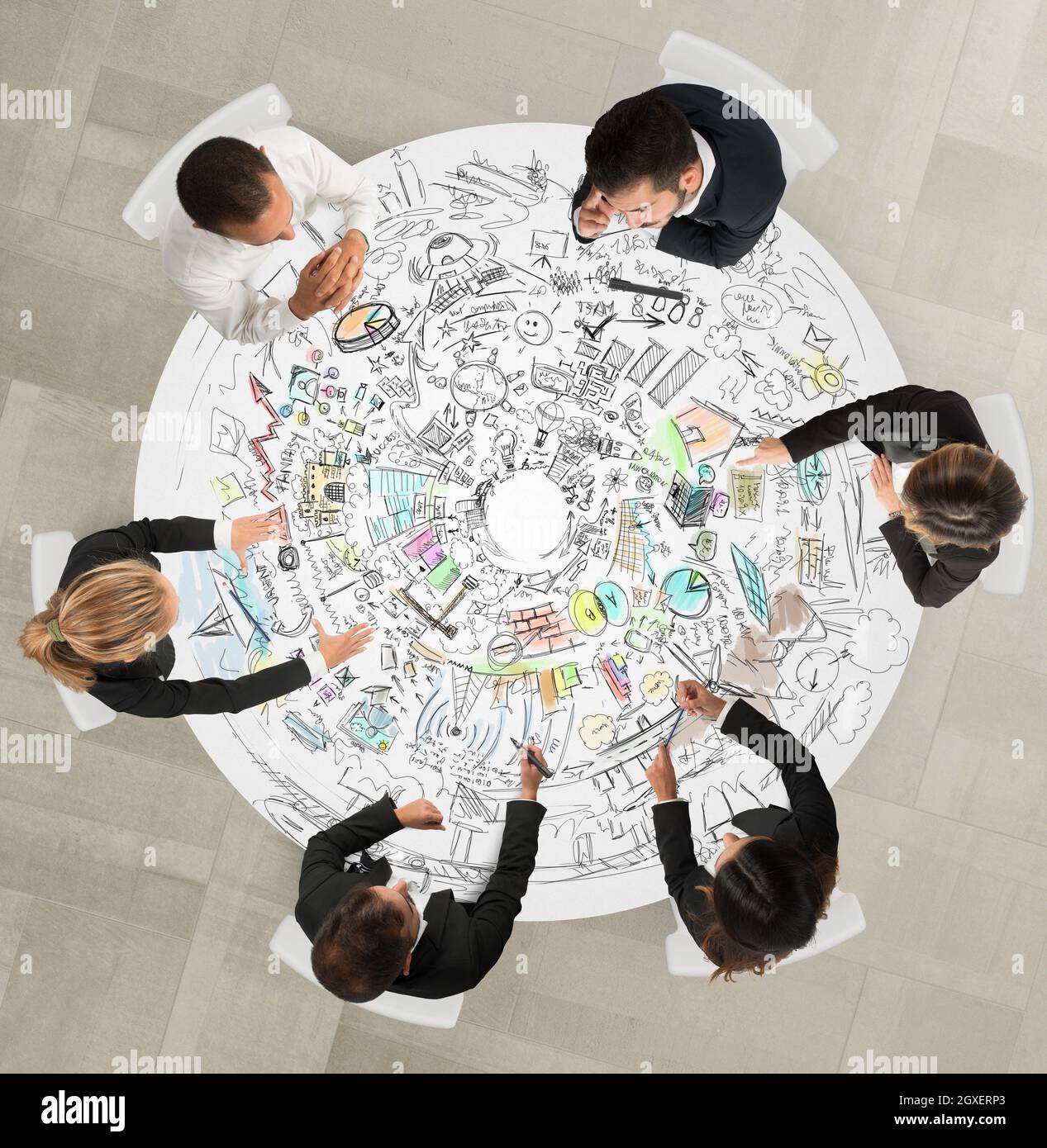 Work group design sitting around a table Stock Photo - Alamy