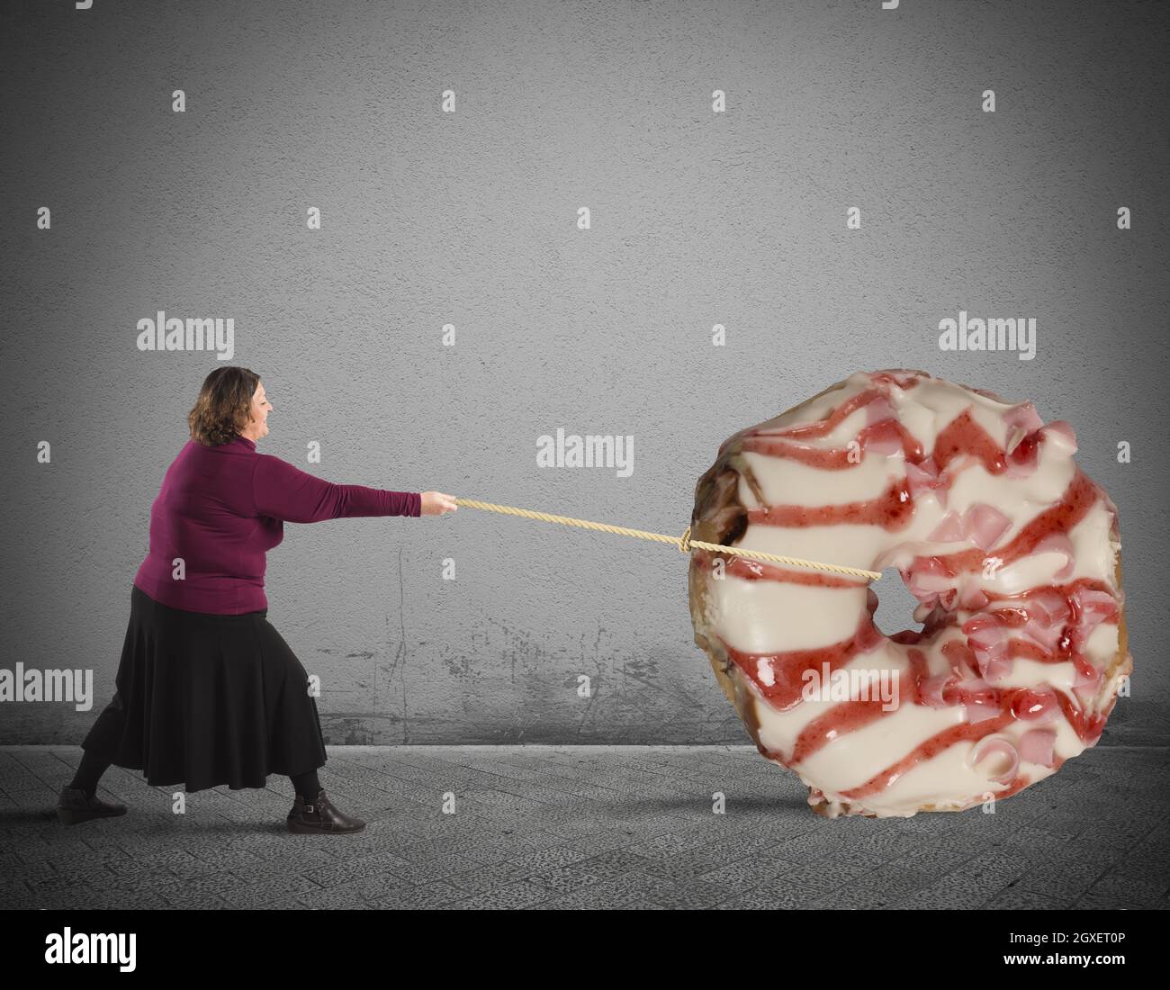 Fat woman with rope pulling a donut Stock Photo - Alamy