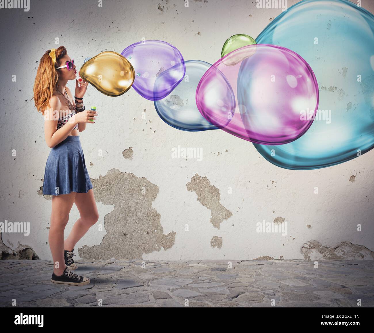 Girl has fun making colorful soap bubbles Stock Photo - Alamy