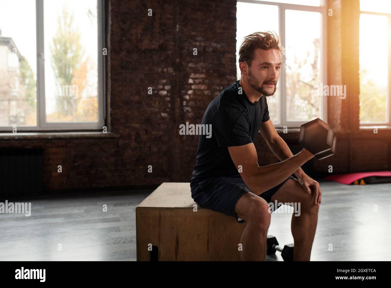 Athletic muscular man training biceps at the gym Stock Photo - Alamy