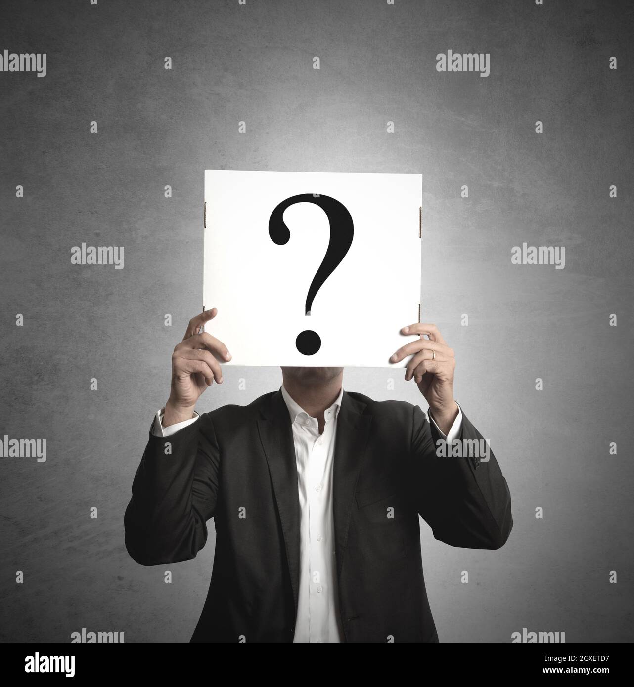 Businessman hiding behind his doubts Stock Photo - Alamy