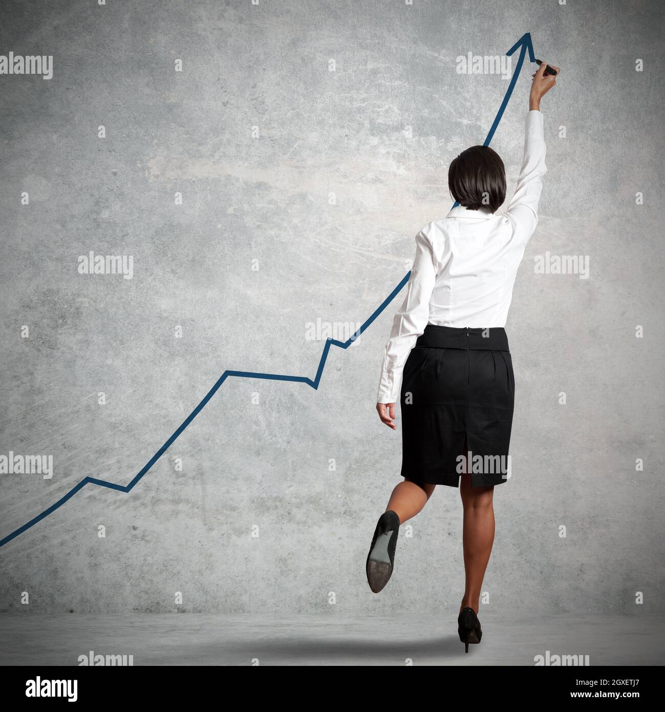 Businesswoman drawing statistics in a wall Stock Photo - Alamy