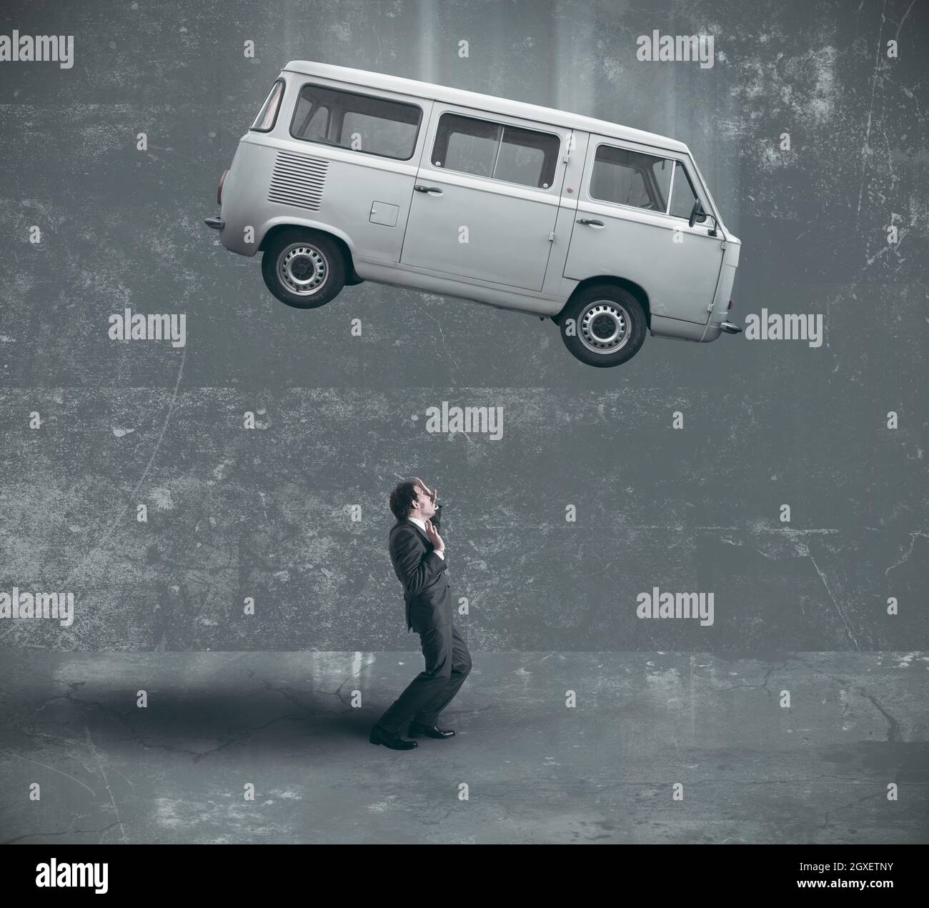 Businessman afraid of being crushed Stock Photo - Alamy