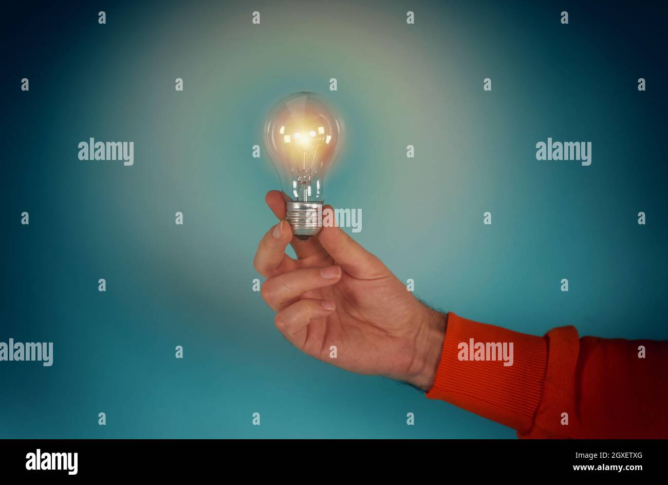 Man holds a lightbulb in hand. concept of creativity and solution Stock ...
