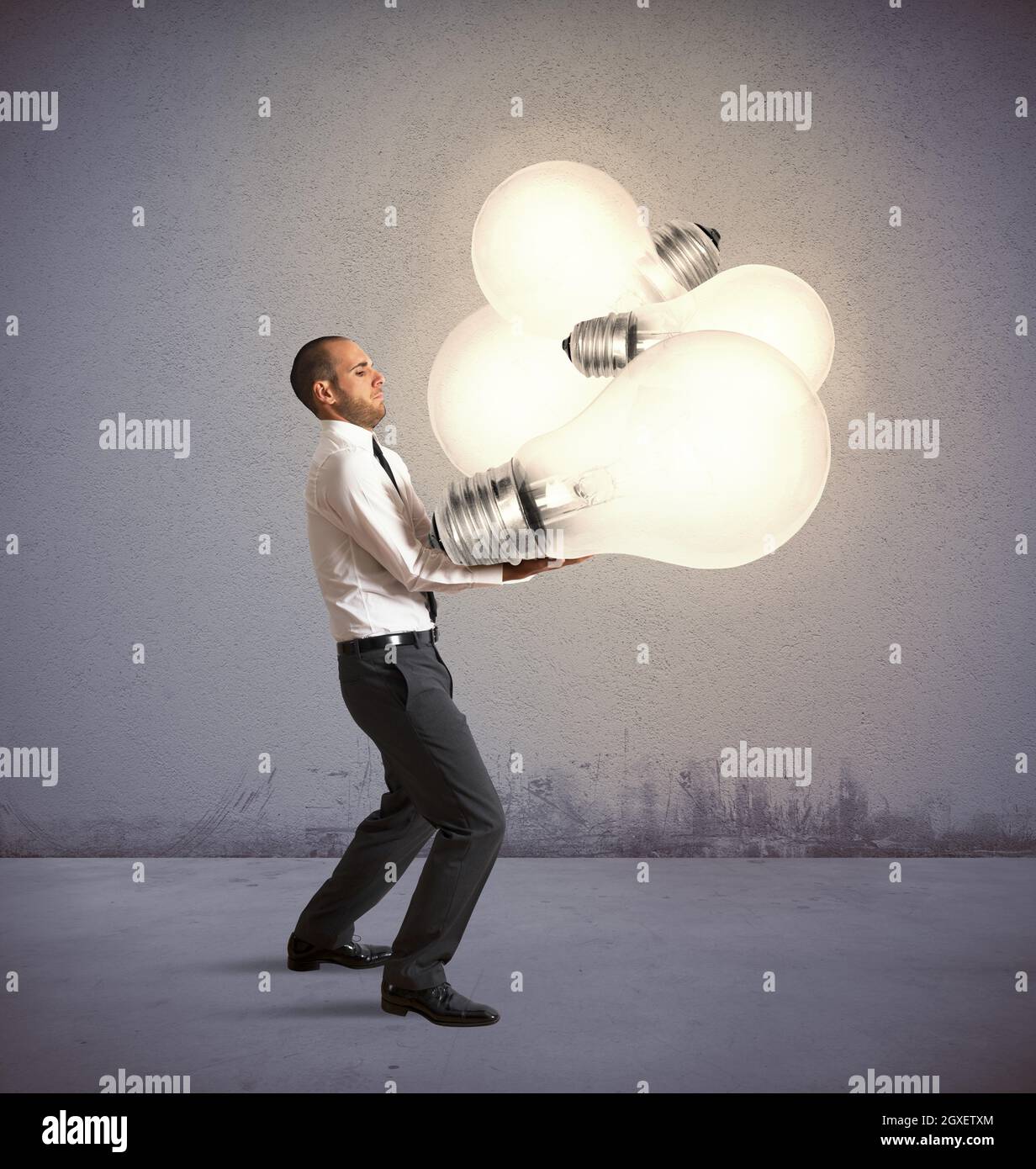 Creative businessman holding a new big idea Stock Photo - Alamy