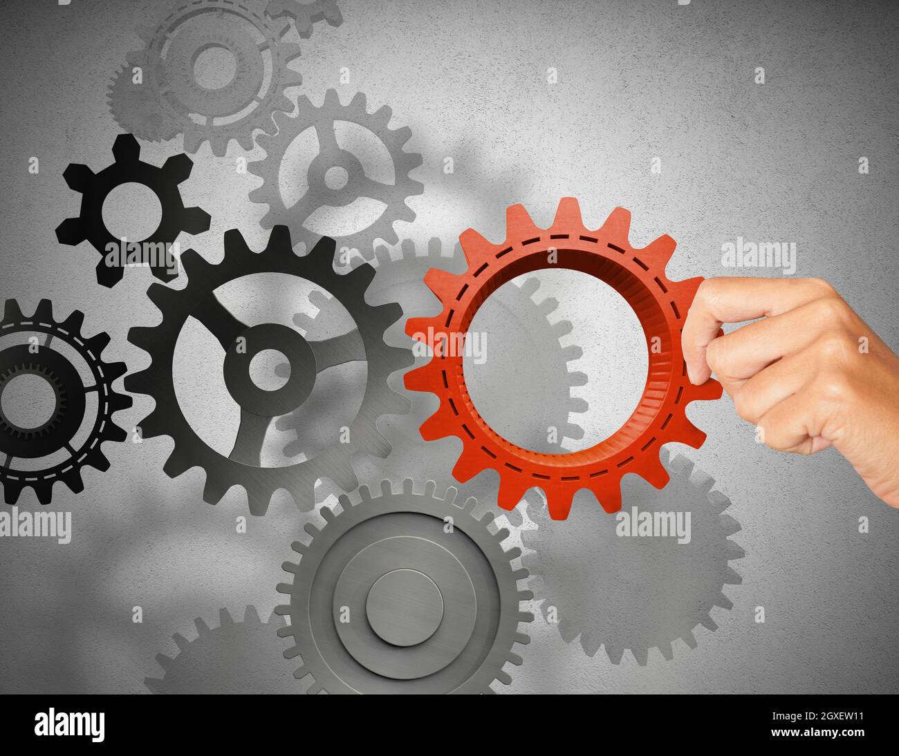 Businessman builds a business system with gear Stock Photo - Alamy