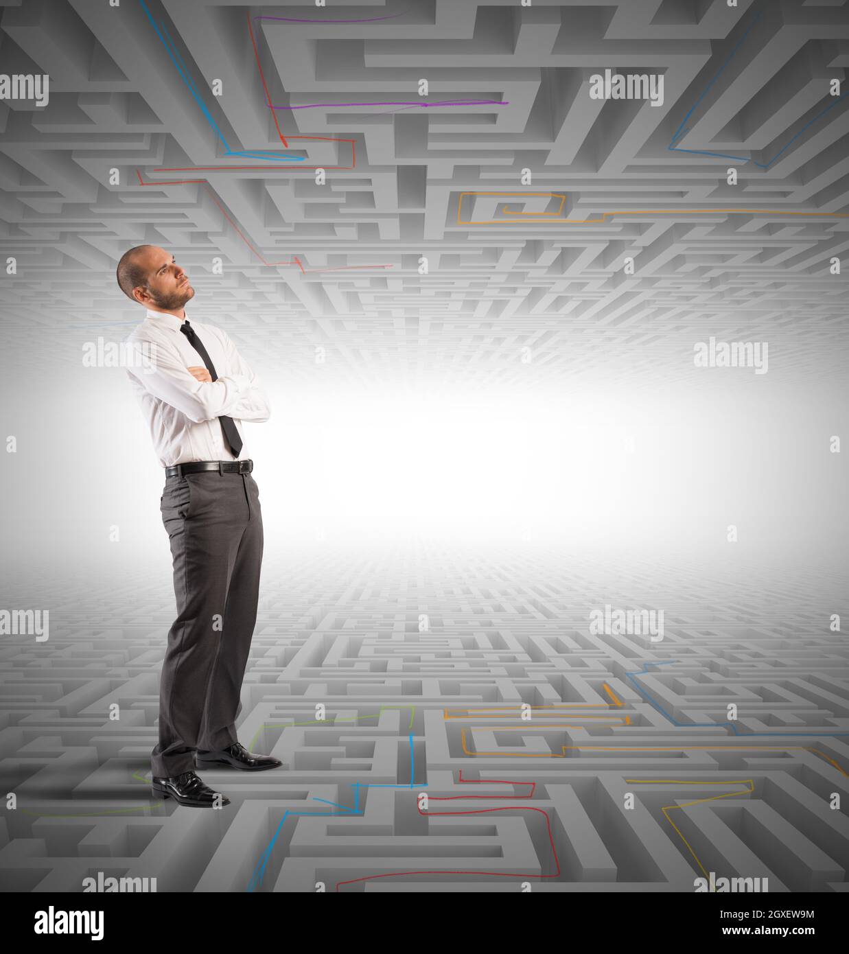 Confused business man seeks a solution to the labyrinth Stock Photo - Alamy