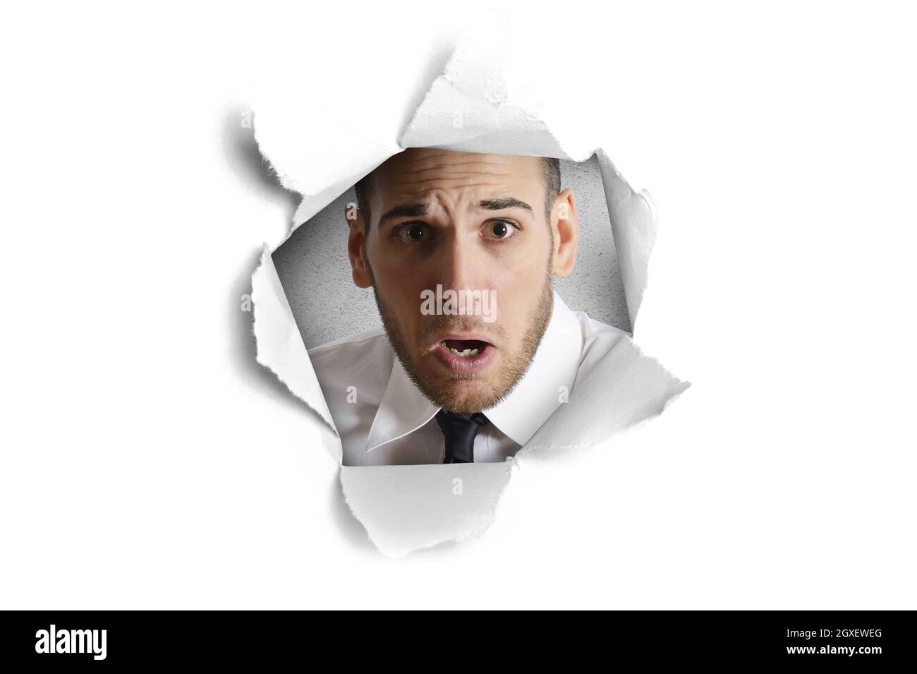 Concept of curiosity with man looking through a paper hole Stock Photo ...