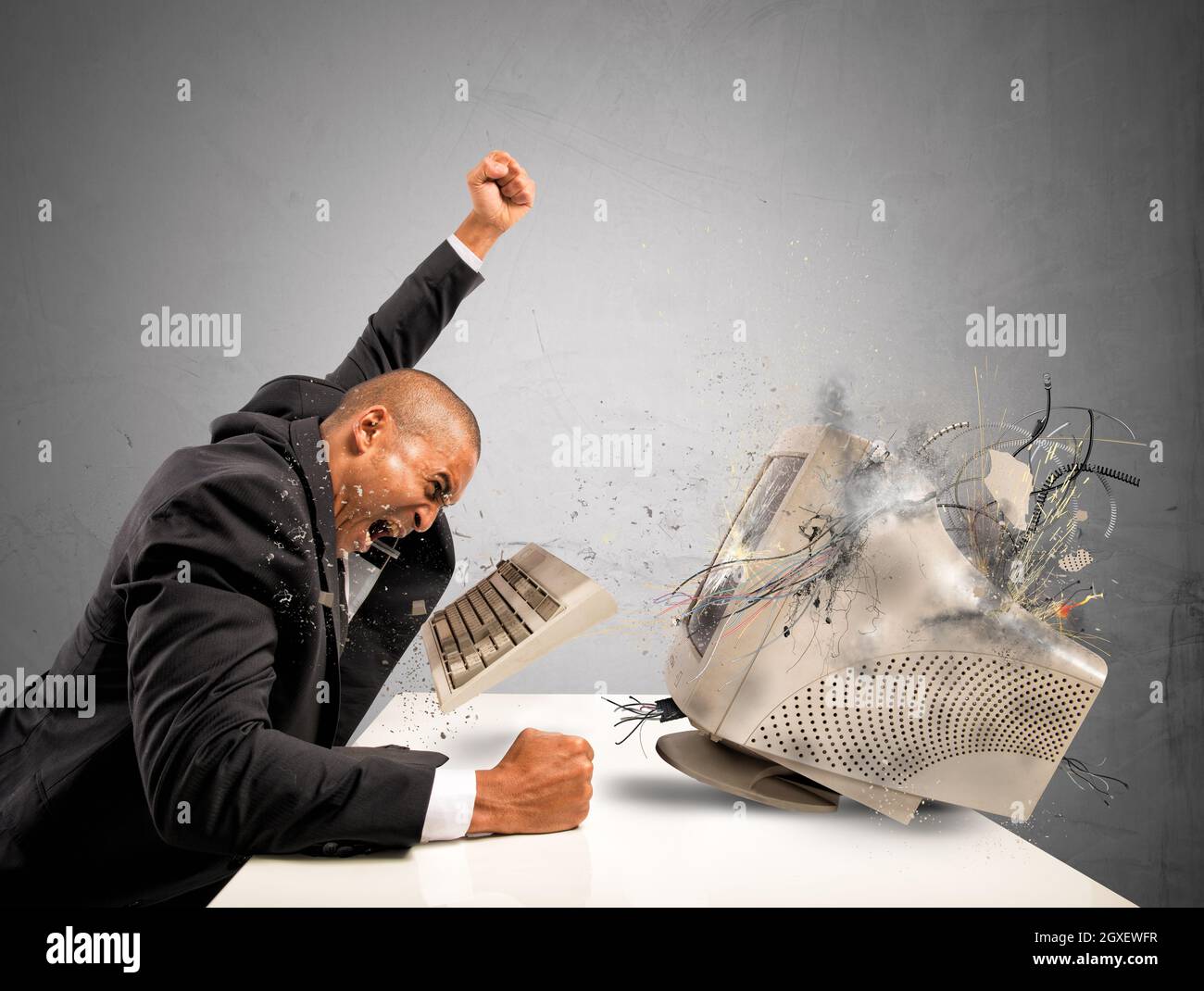 Businessman who breaks furiously an old computer Stock Photo - Alamy