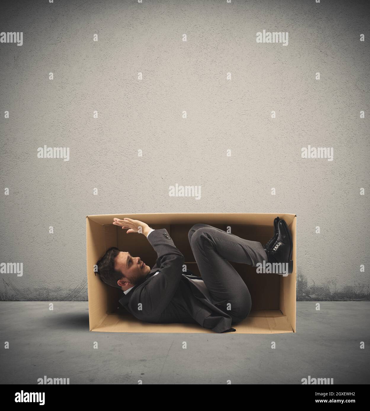Concept of tight work with a businessman inside a carton Stock Photo ...