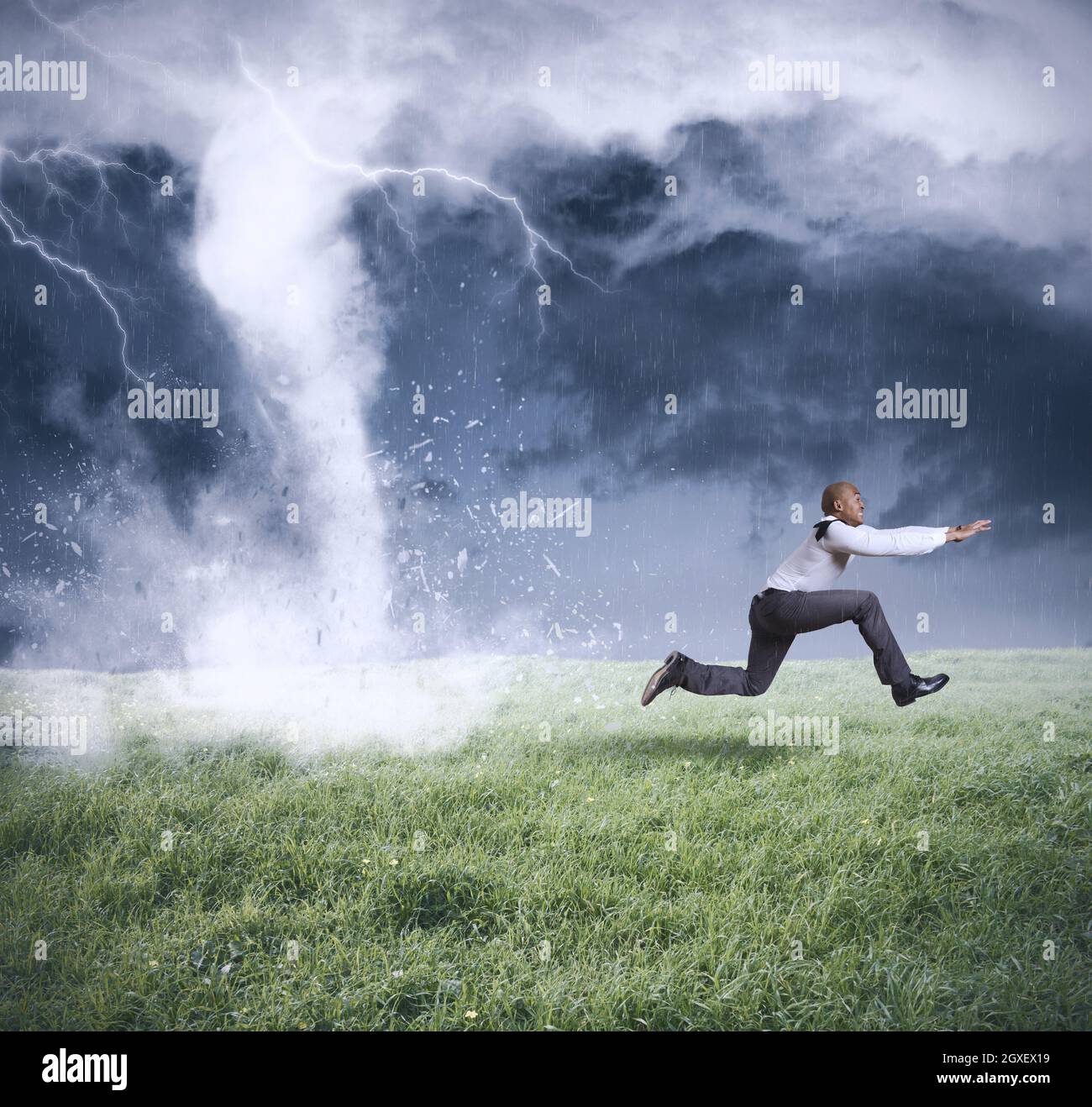 Running businessman escapes from a business storm Stock Photo - Alamy