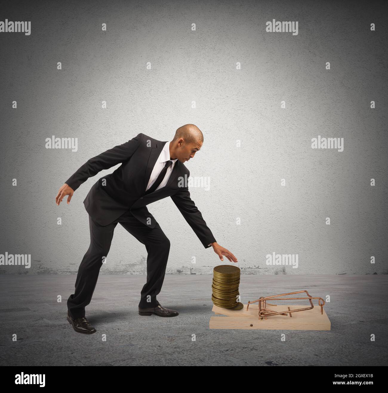Concept of business trap with businessman taking money from a mousetrap ...