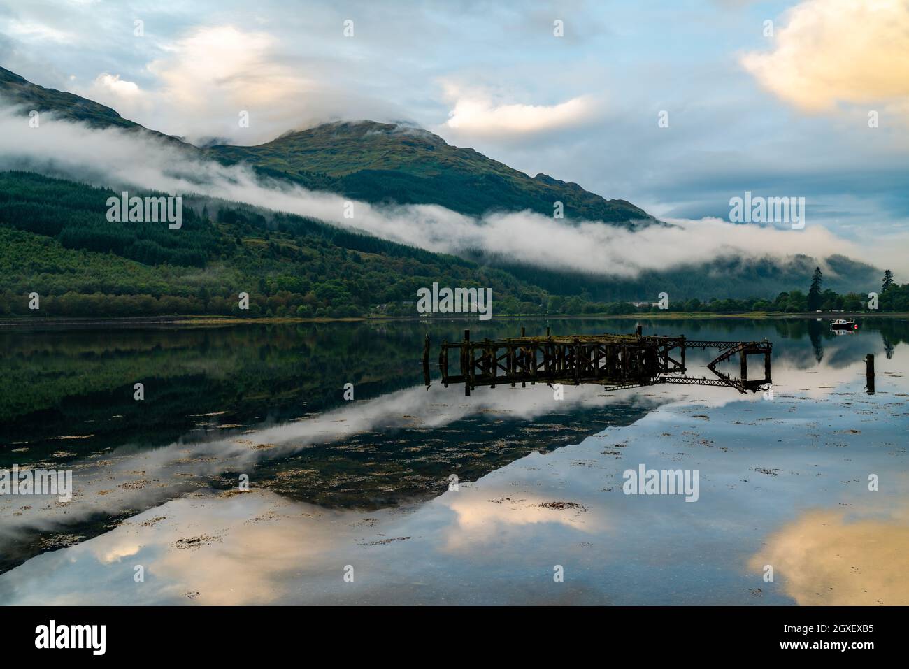 Sunset over Loch Long with low clouds and reflections in water, Argyll ...