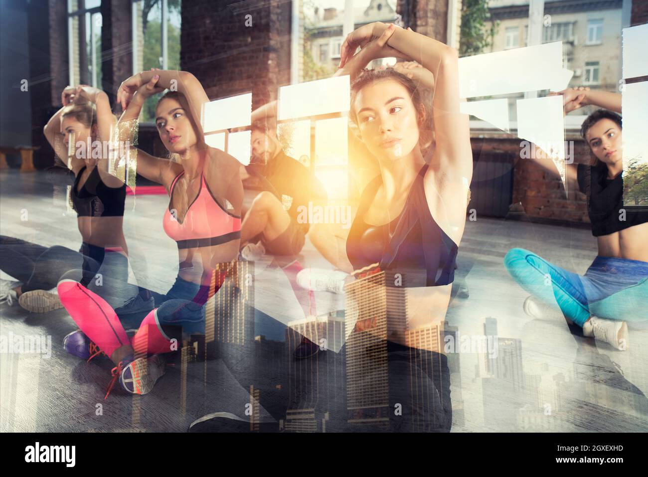 Class of people do stretching at the gym. Double exposure Stock Photo ...