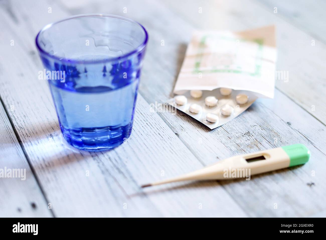 Recovery at home, a thermometer and tablets Stock Photo - Alamy
