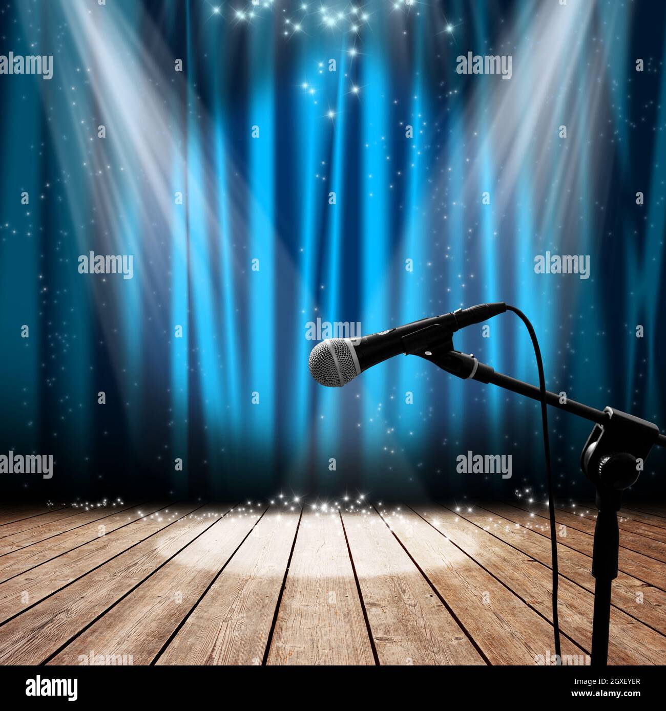 Blue stage with microphone and spotlight Stock Photo - Alamy