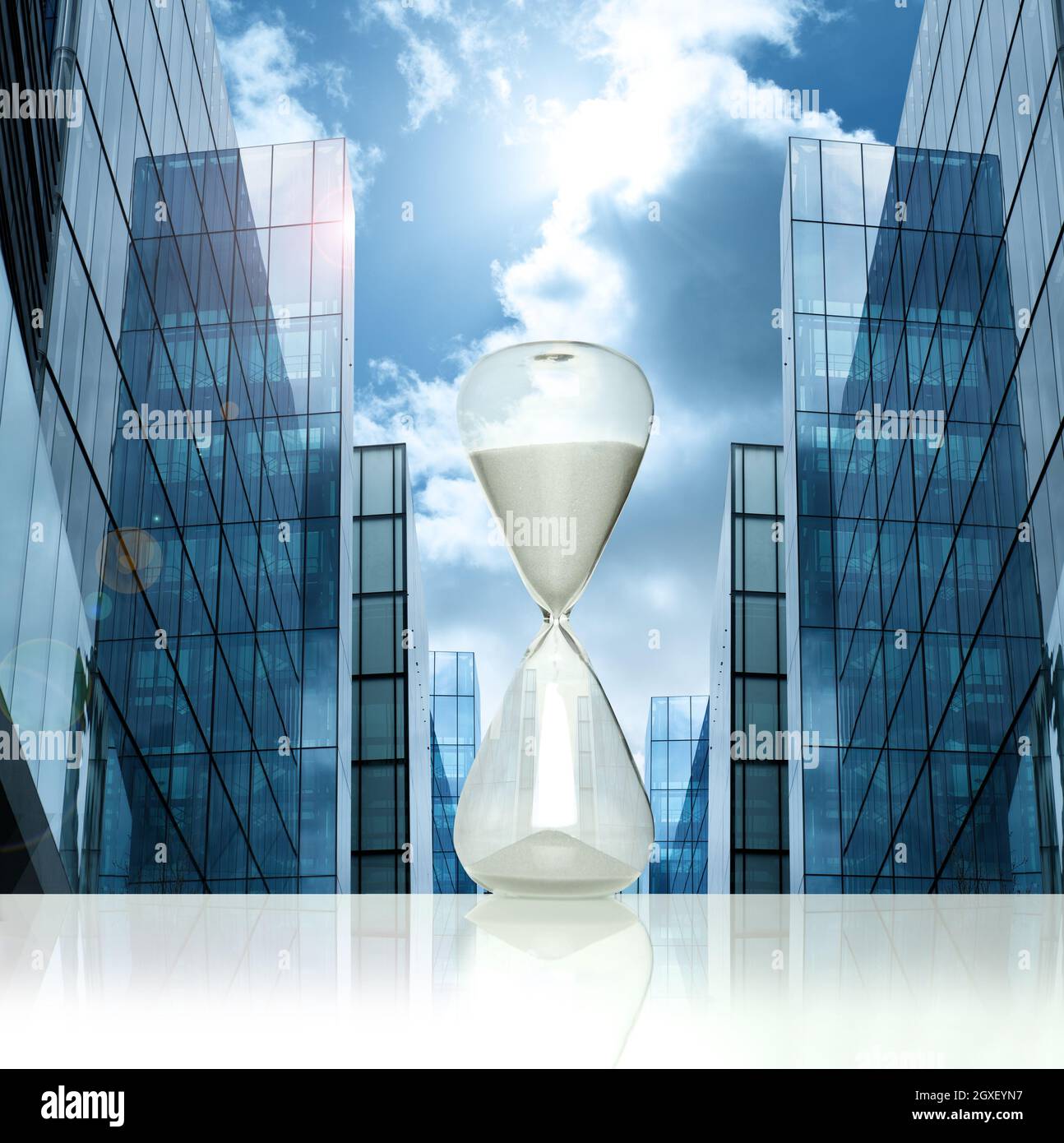 Hourglass in front of modern skyscraper Stock Photo - Alamy