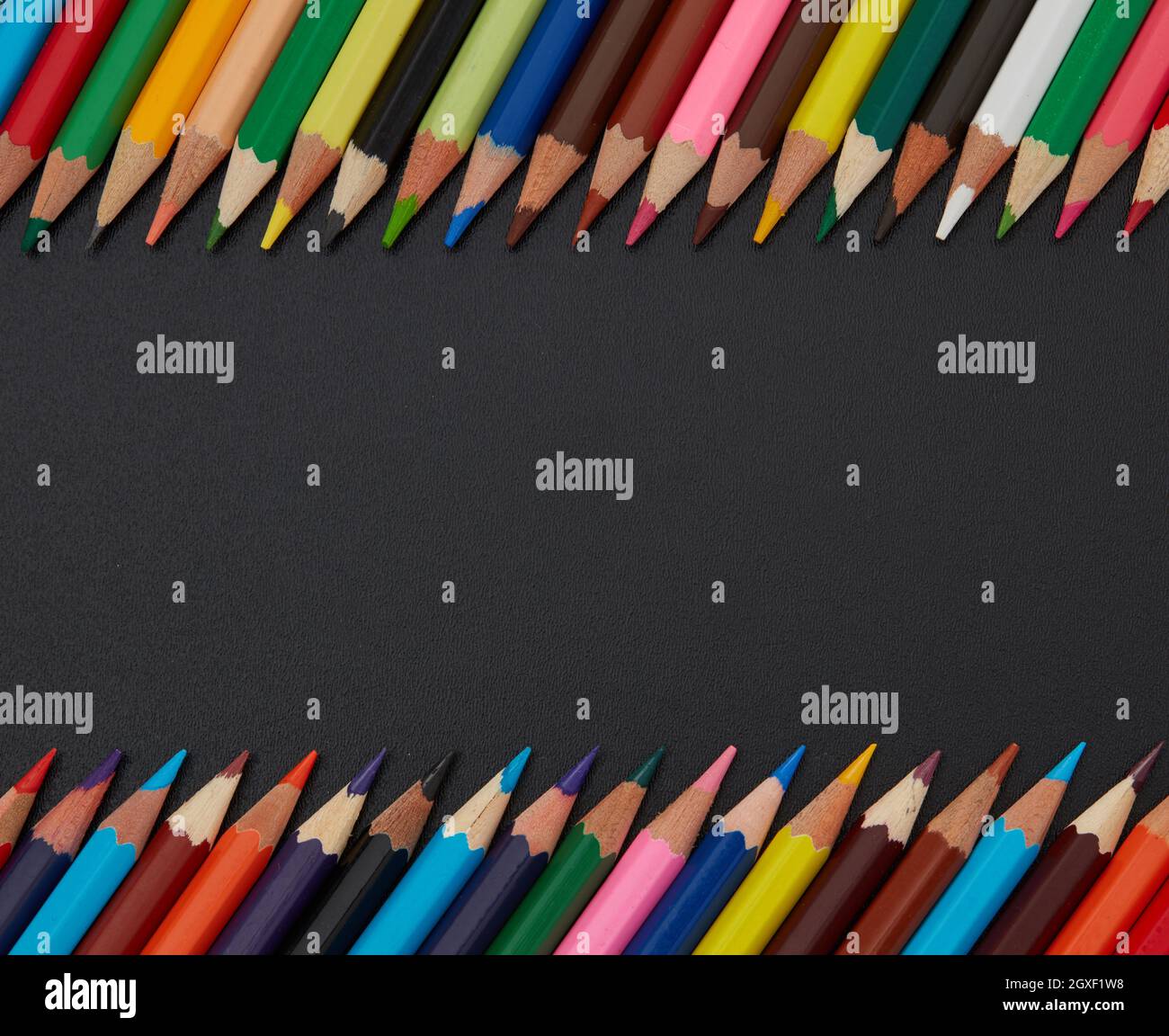 Multi-colored pencils on black background Stock Photo - Alamy