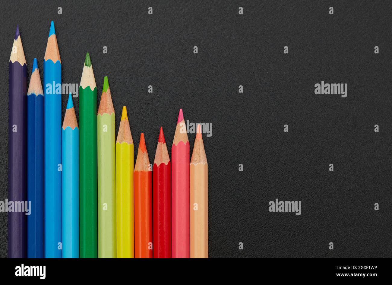 Multi-colored pencils on black background Stock Photo - Alamy