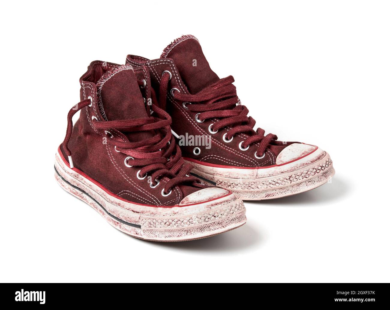 Used canvas shoes on white background Stock Photo - Alamy
