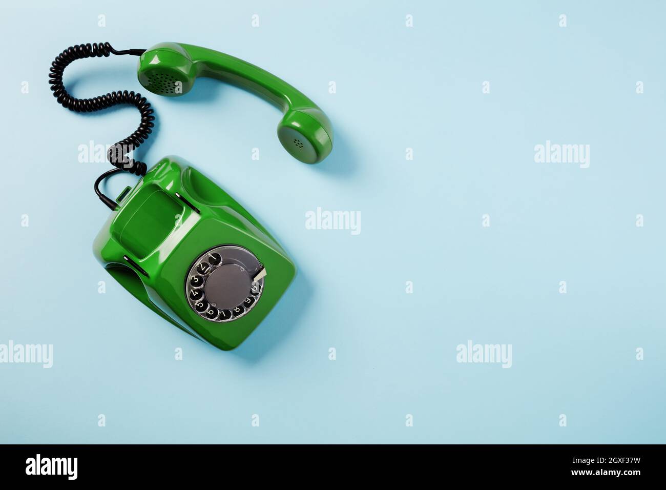 Rotary green phone on blue background Stock Photo - Alamy