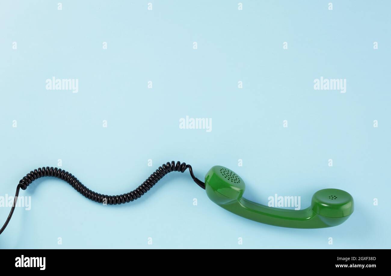 Rotary green phone receiver on blue background Stock Photo - Alamy