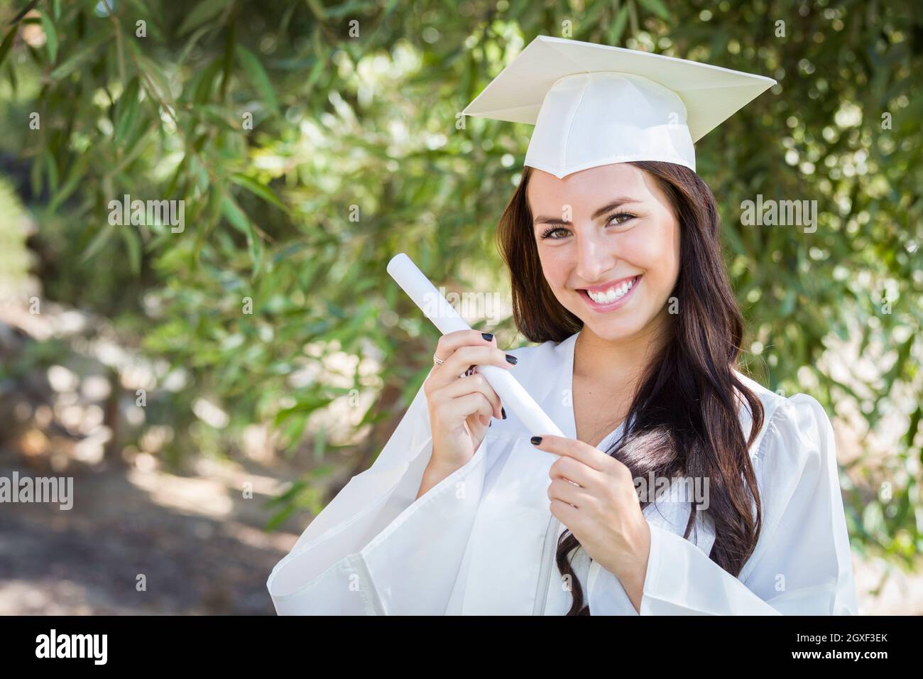 Attractive Mixed Race Girl Celebrating Graduation Outside In Cap and ...