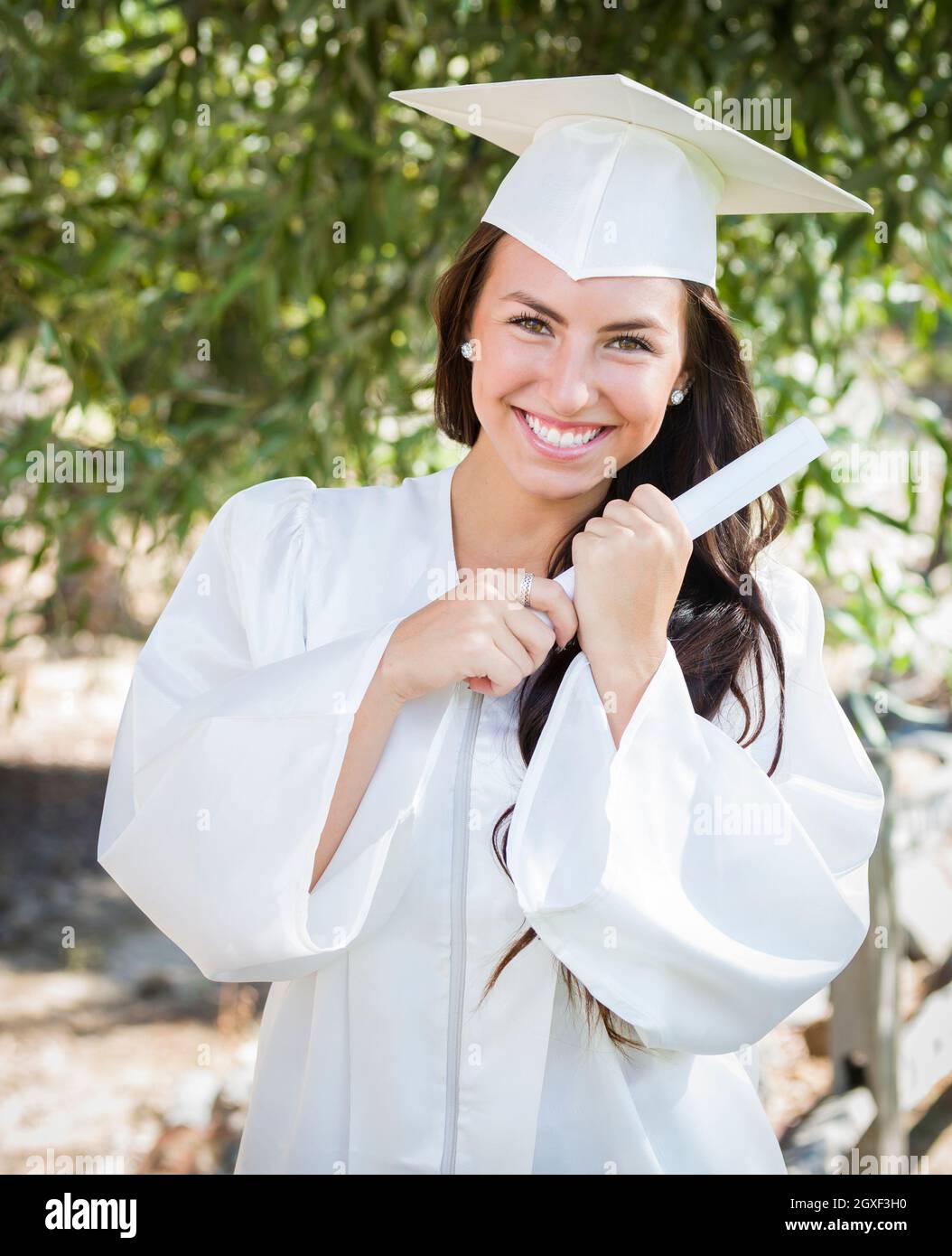 Attractive Mixed Race Girl Celebrating Graduation Outside In Cap and ...