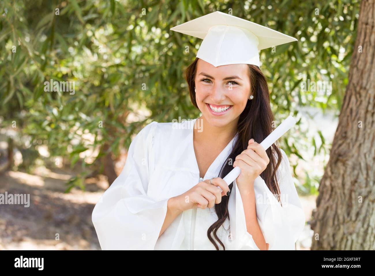 Attractive Mixed Race Girl Celebrating Graduation Outside In Cap and ...