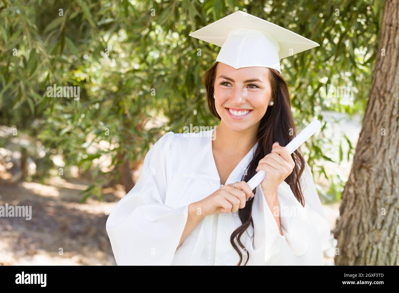 Attractive Mixed Race Girl Celebrating Graduation Outside In Cap and ...