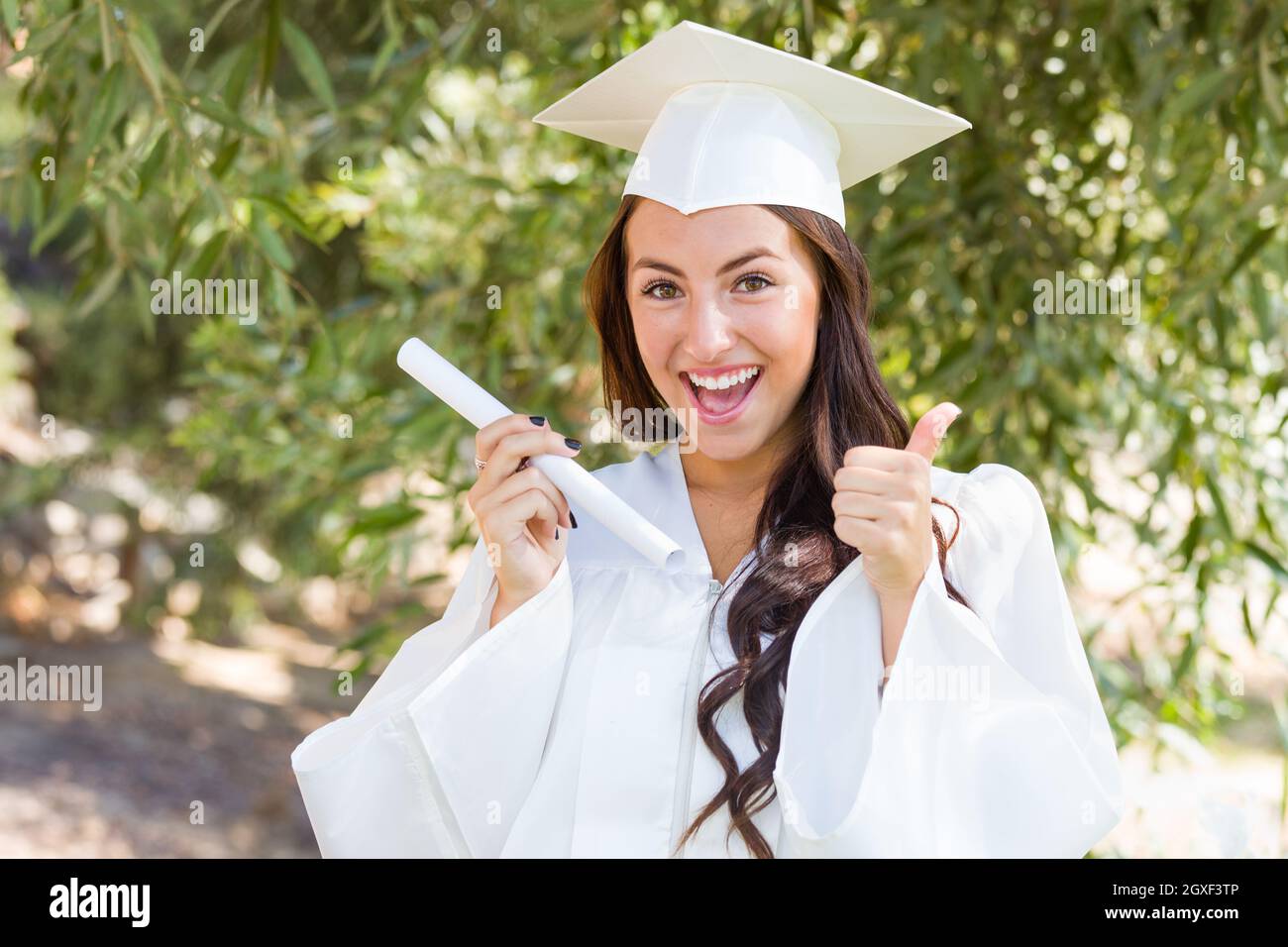 Attractive Mixed Race Girl Celebrating Graduation Outside In Cap and ...