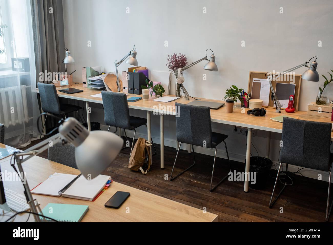 Part of contemporary office with rows of workplaces for white collar ...