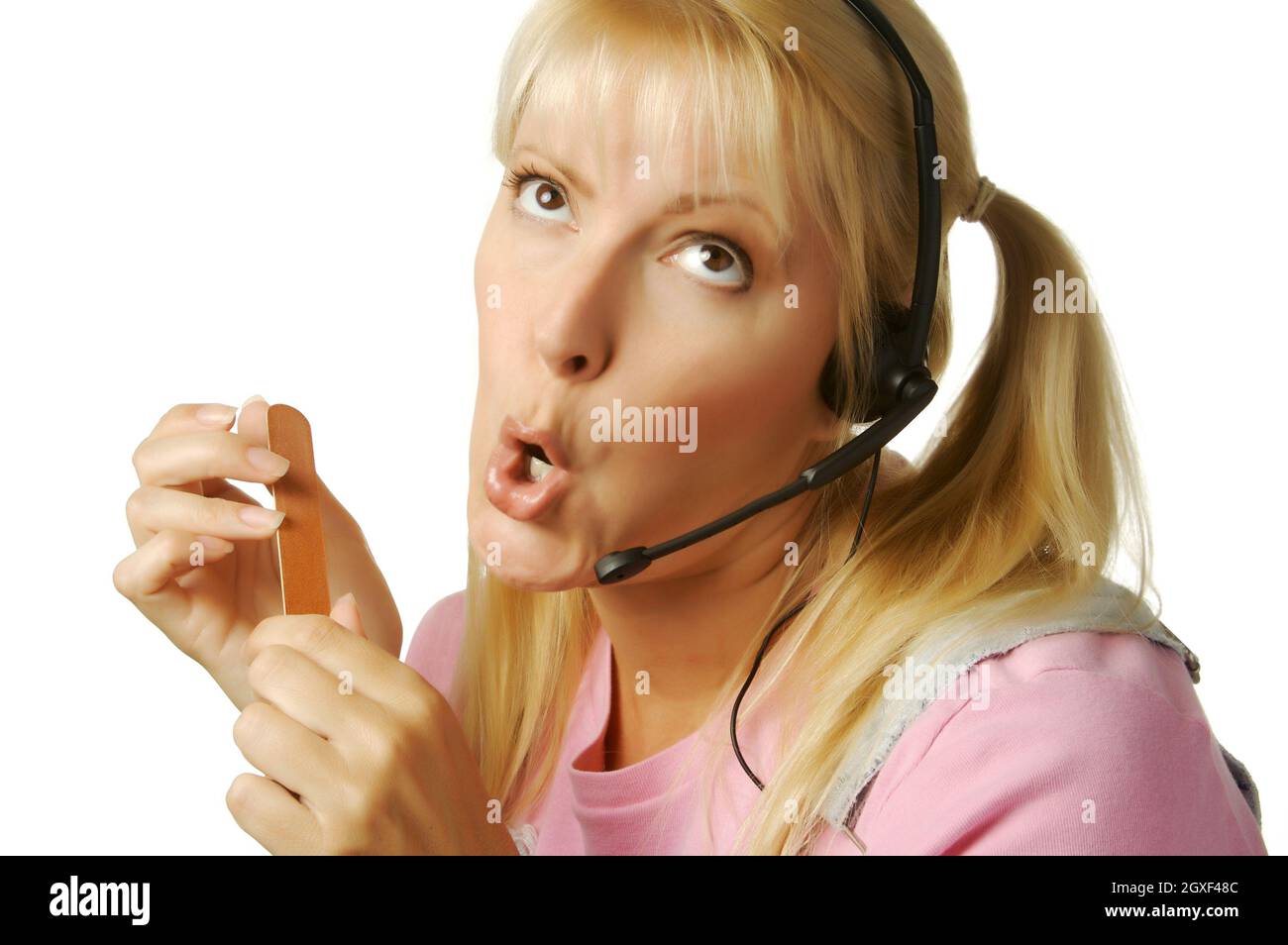 An obviously bored customer support girl waiting for the clock to hit 5 ...