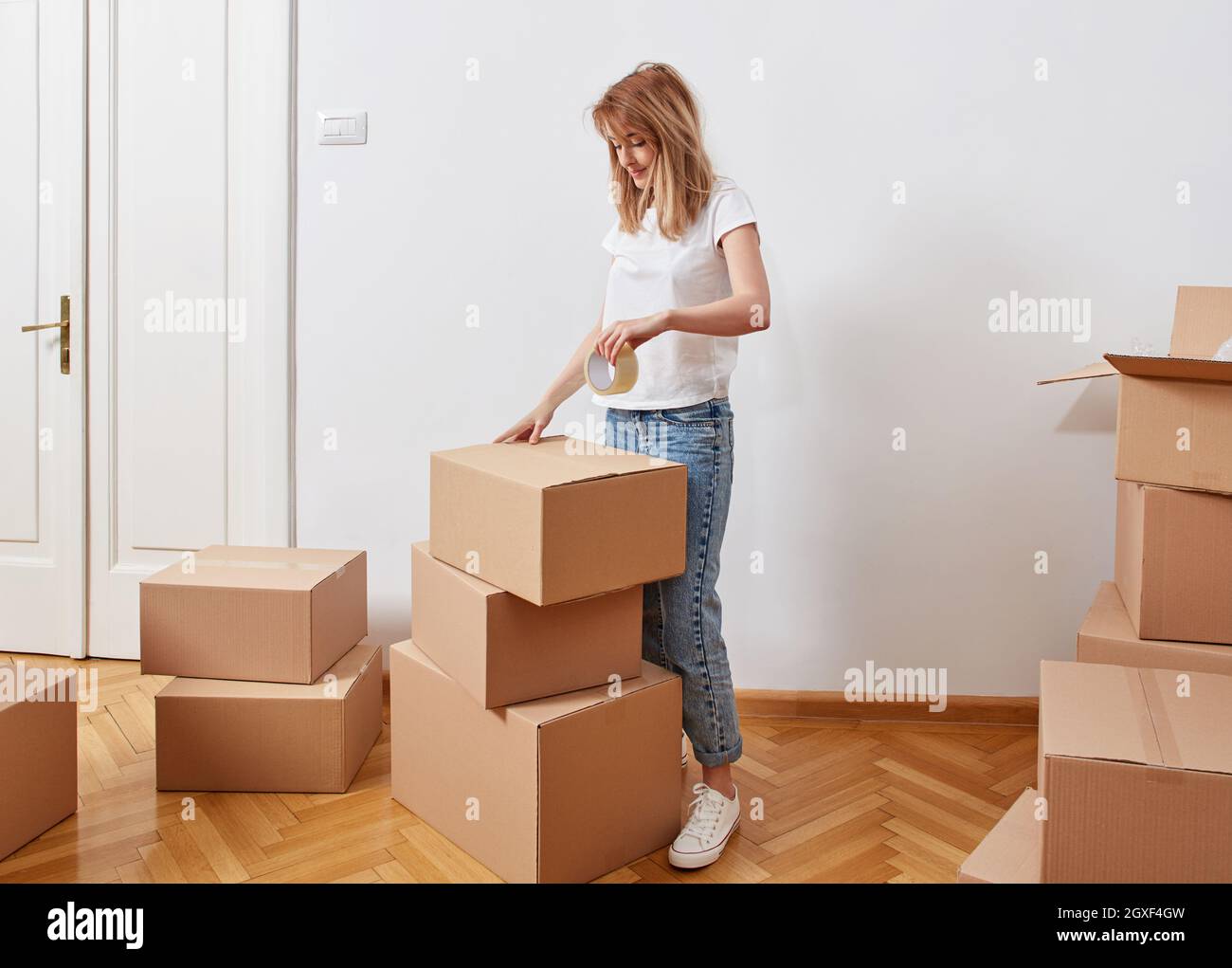 Woman with cardboard boxes Stock Photo - Alamy