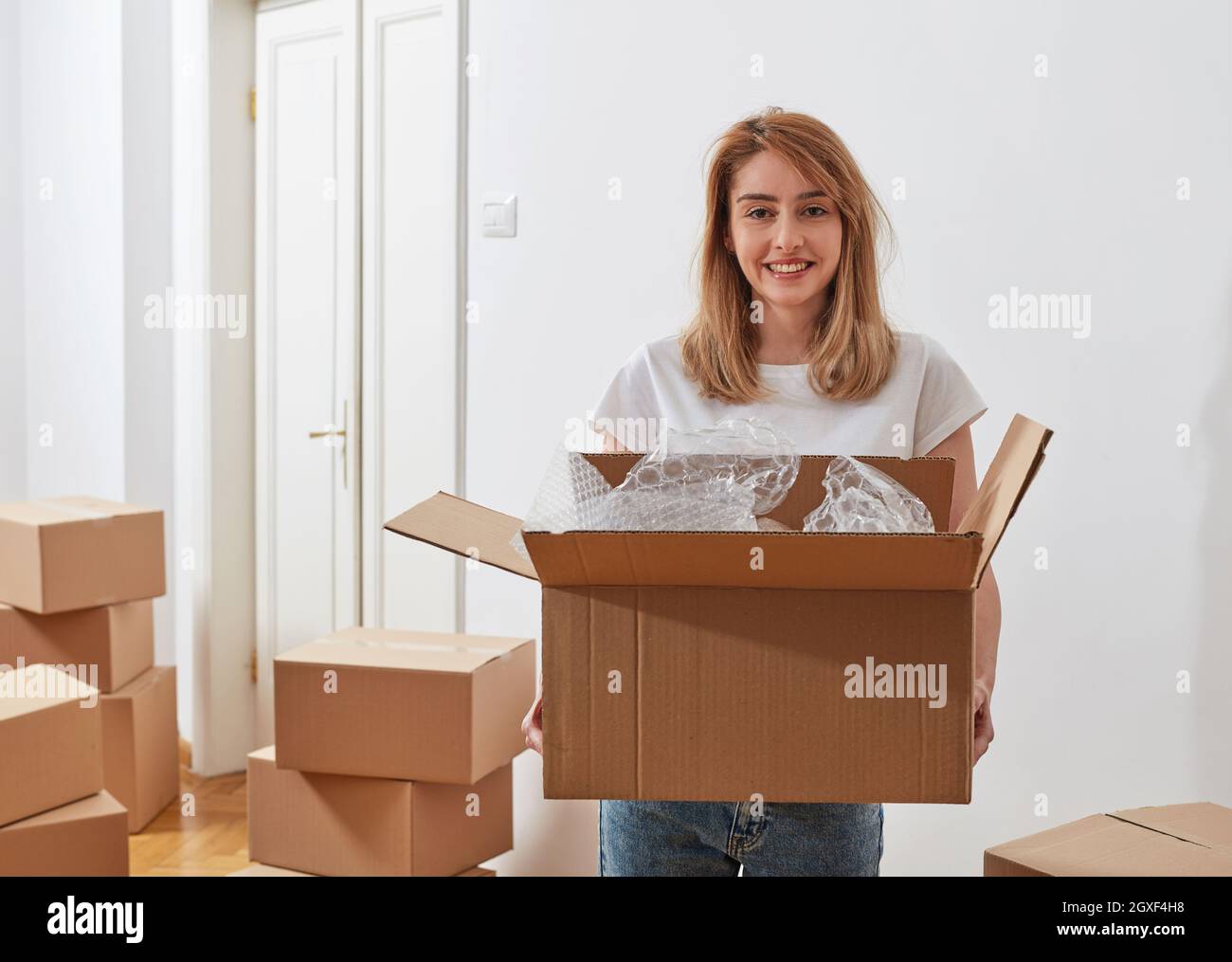 Woman with cardboard boxes Stock Photo - Alamy