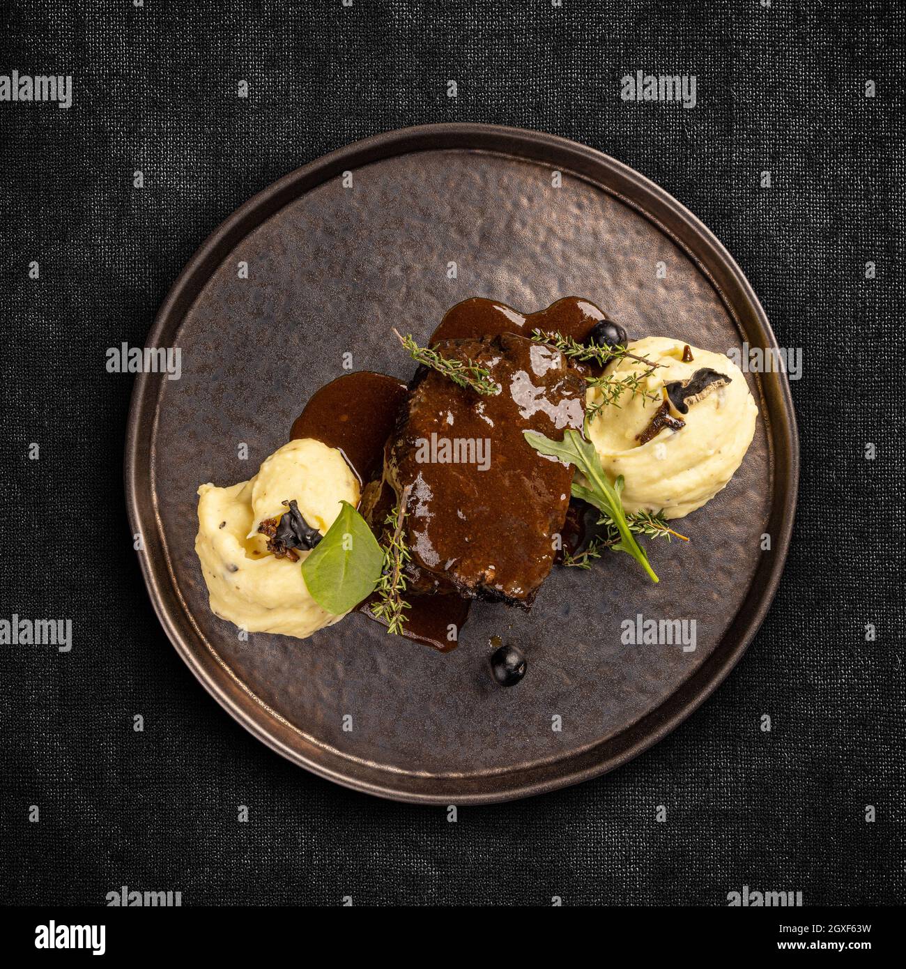 Flat lay of smoked barbecue beef topped with bbq sauce served with ...