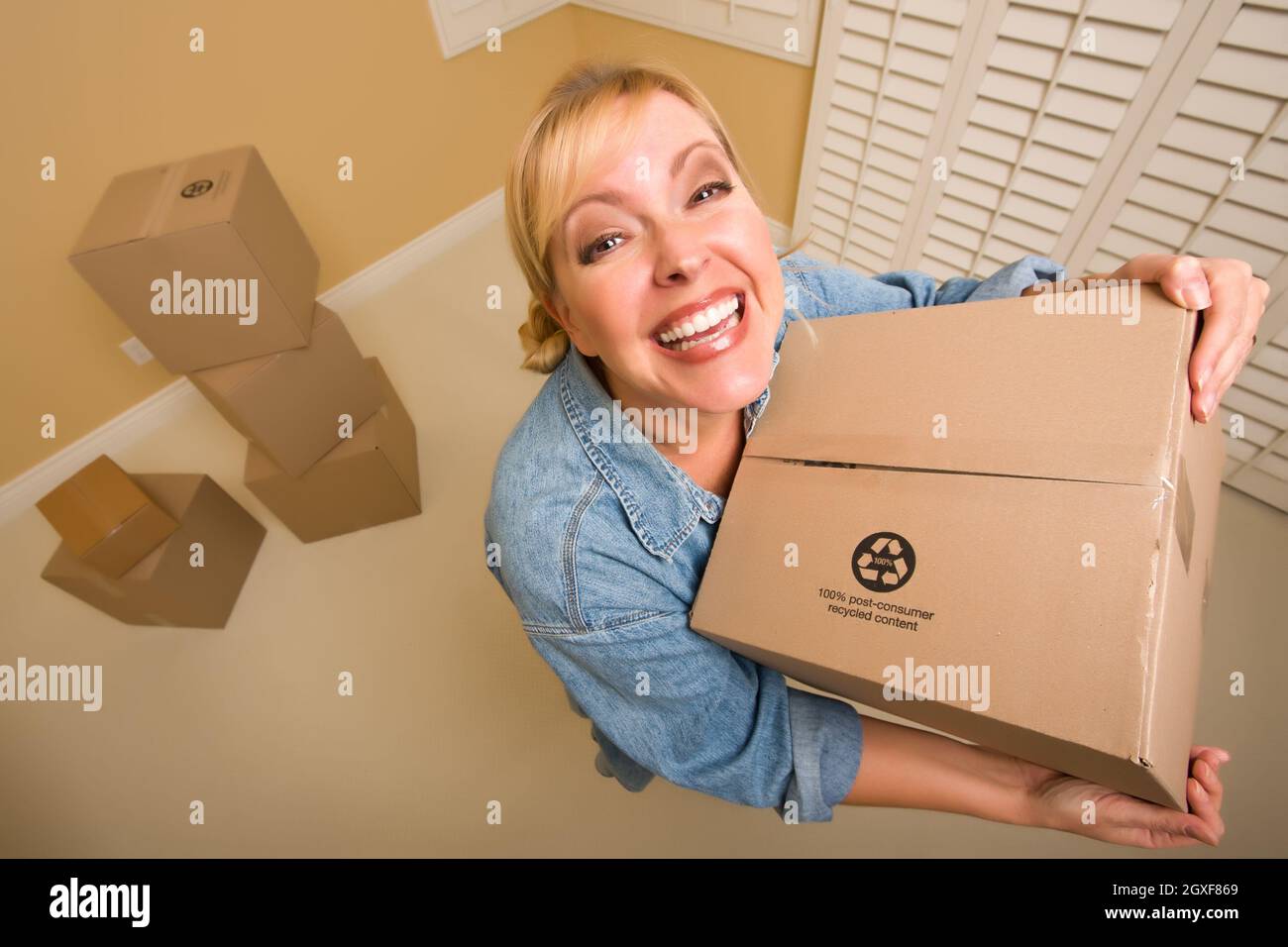 Excited Woman Holding Moving Boxes in Empty Room Taken with Extreme ...