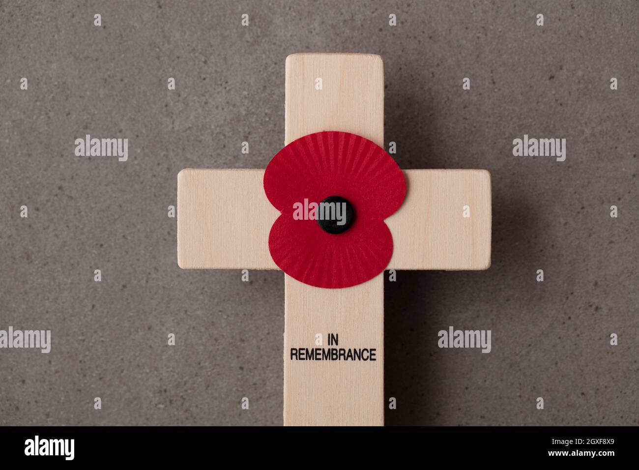A red remembrance poppy on a wooden cross. Military remembrance day ...