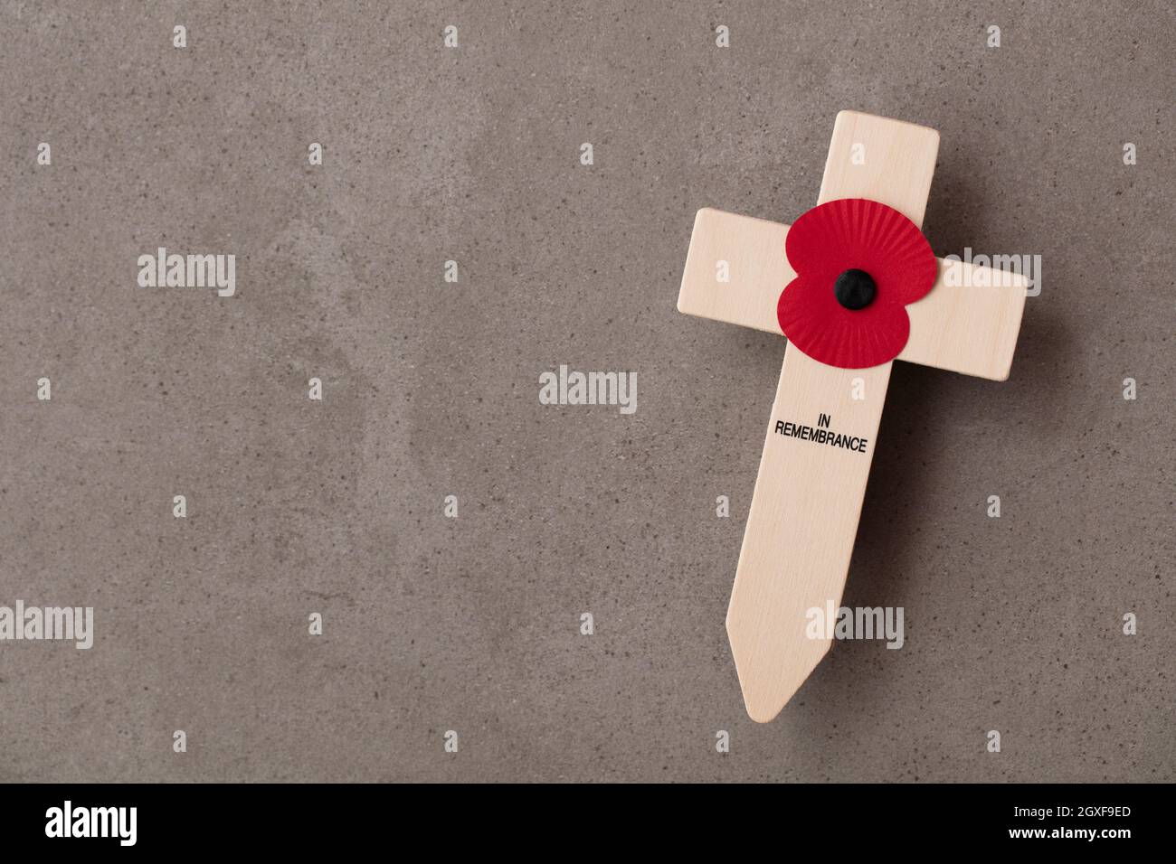A red remembrance poppy on a wooden cross. Military remembrance day ...